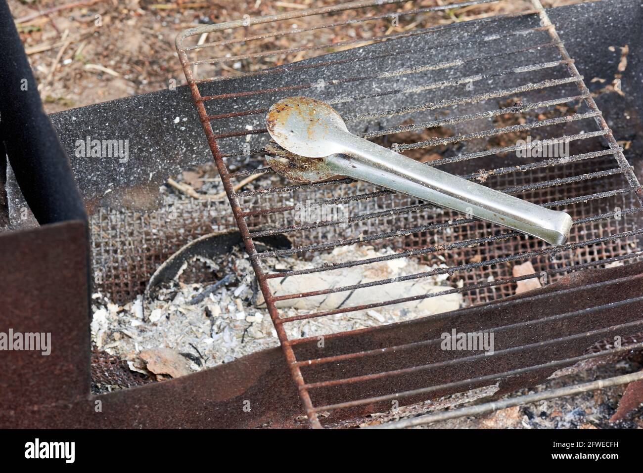 empty barbecue grill and spatula for turning meat extinguished fire ...