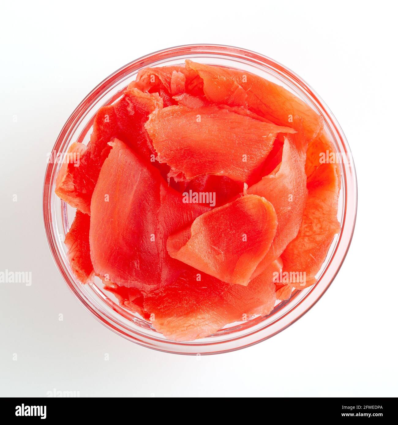 Red pickled ginger in glass bowl isolated on white background with ...