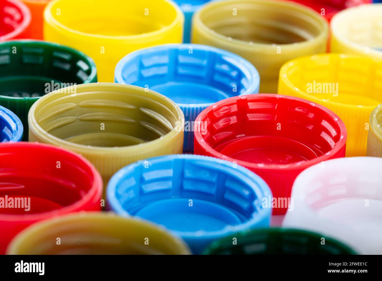 Plastic bottle caps background. Cap material is recyclable. Recycling ...