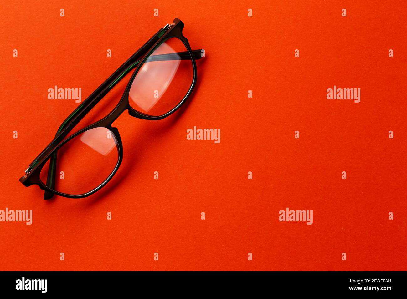 Stylish glasses for vision on an orange background. Fashion accessory ...