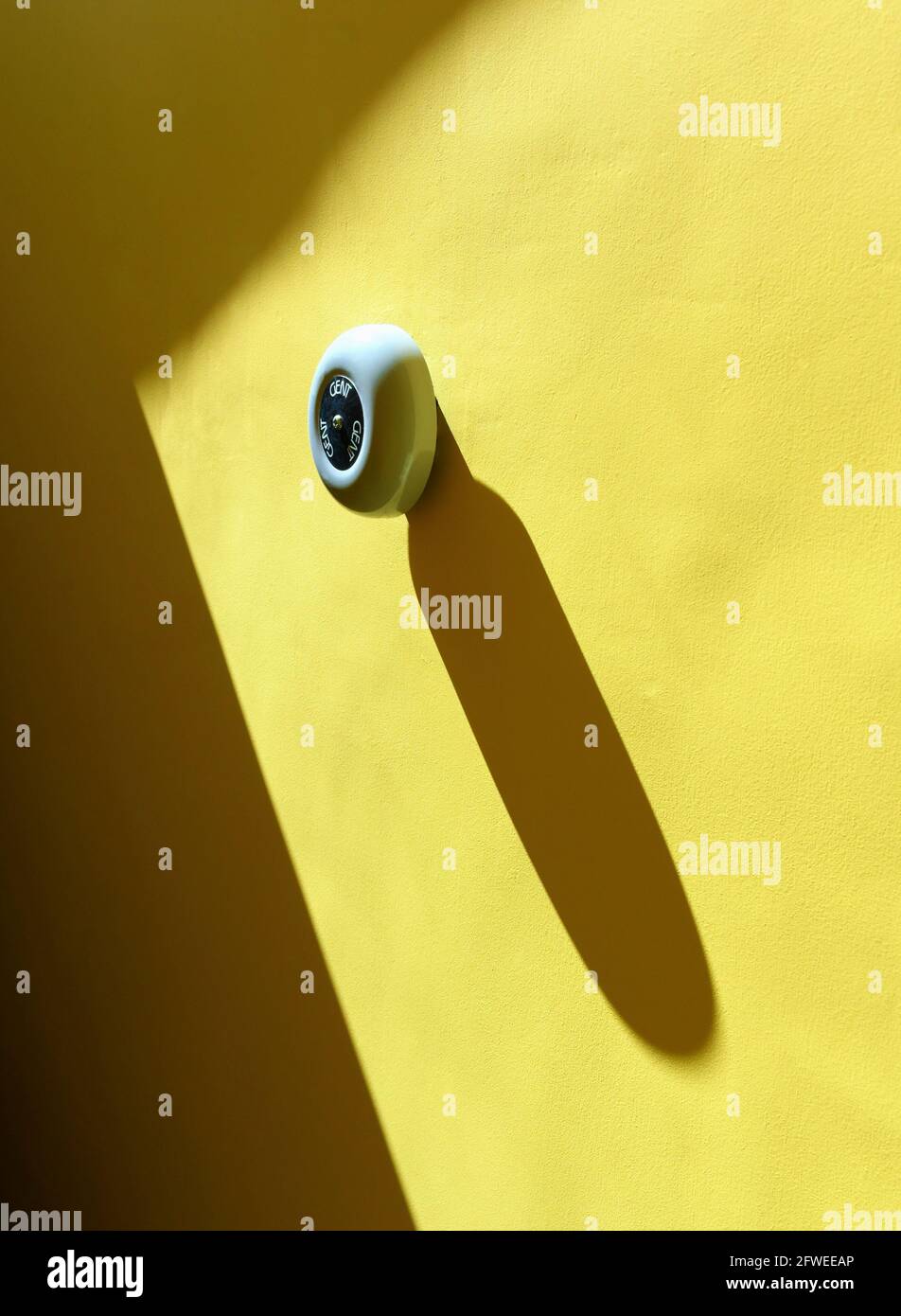 Gent fire alarm bell on yellow painted wall Stock Photo - Alamy