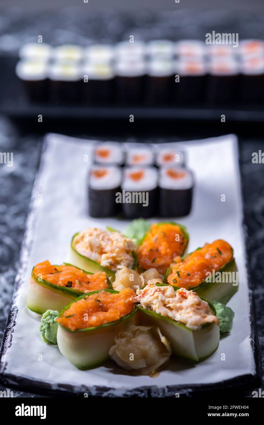 set of sushi rolls with seafood on a black stone background Stock Photo ...