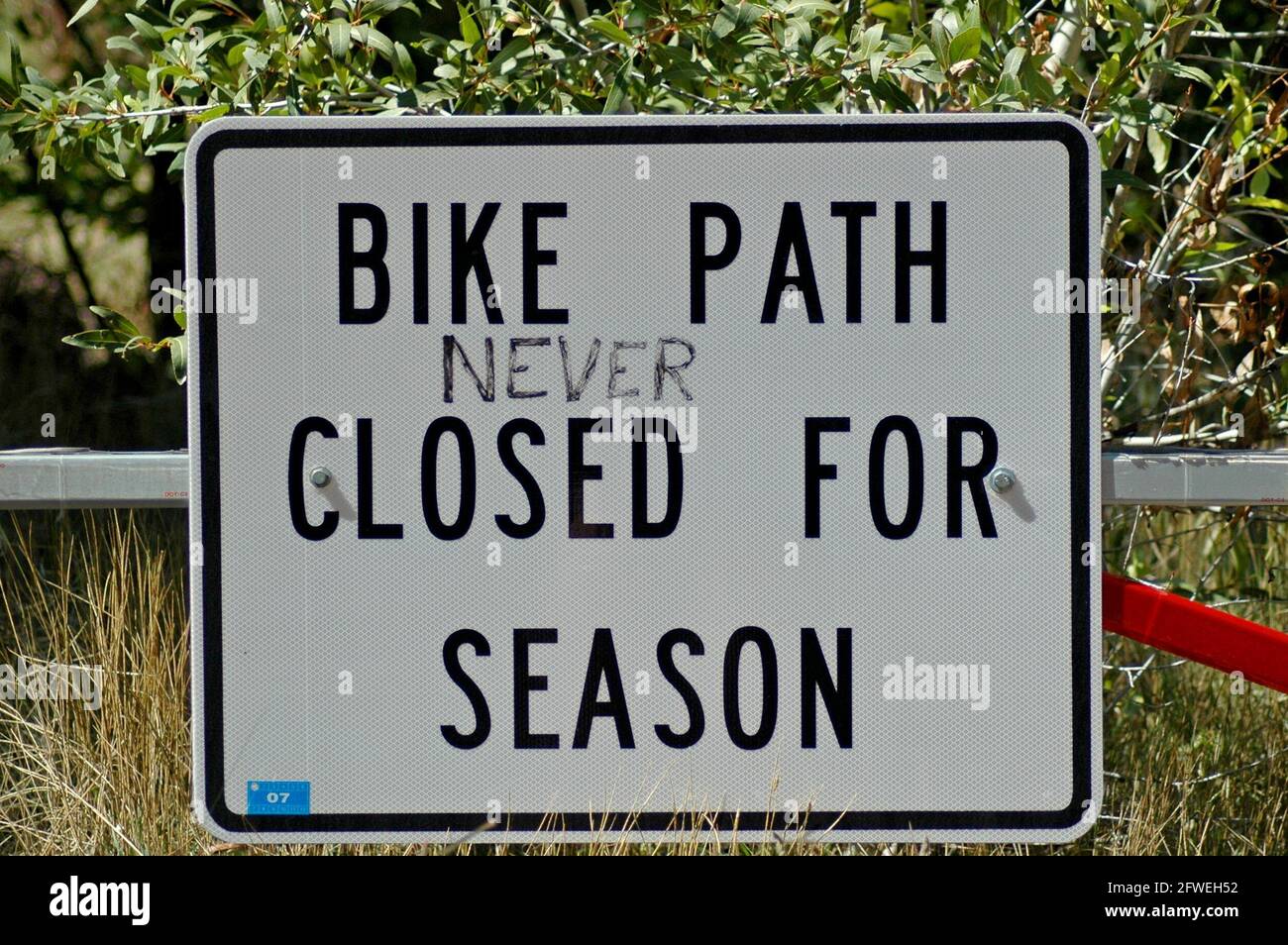 a graffitied and altered bike path sign at Glenwood Springs, Colorado ...