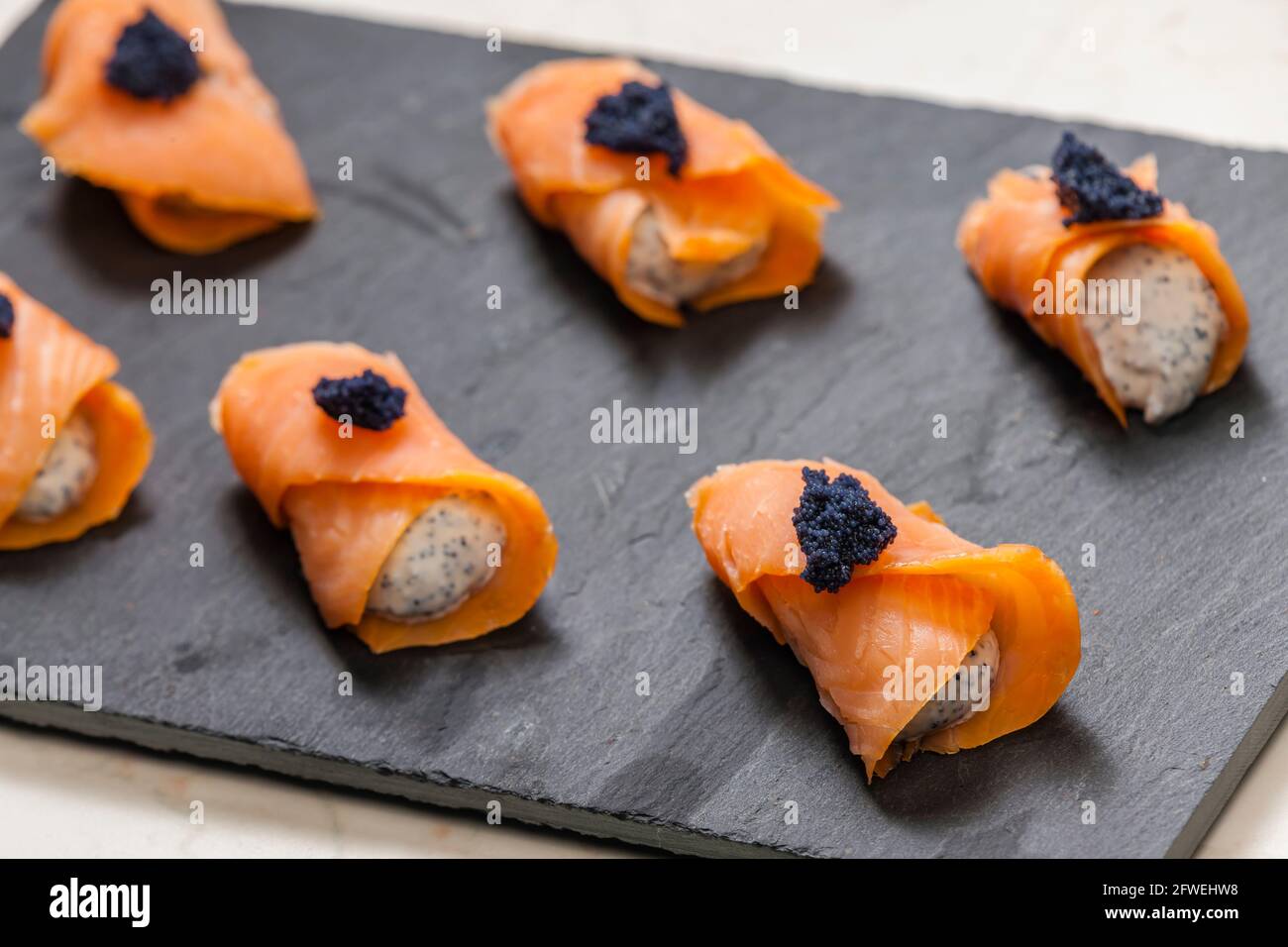 smoked salmon rolls filled with cream cheese and black caviar Stock ...