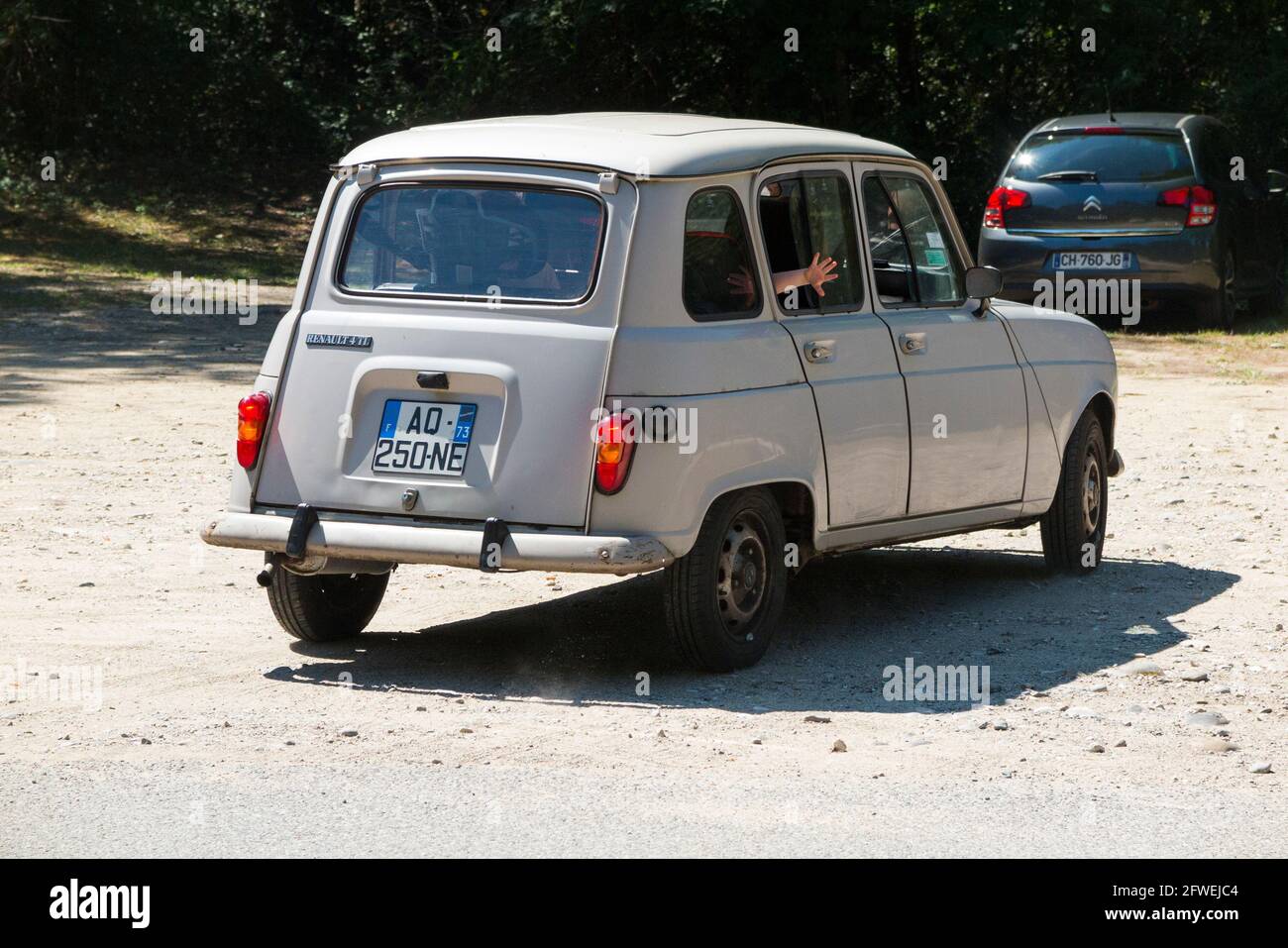 Renault 4 L car driver driving on rough car park country road near ...