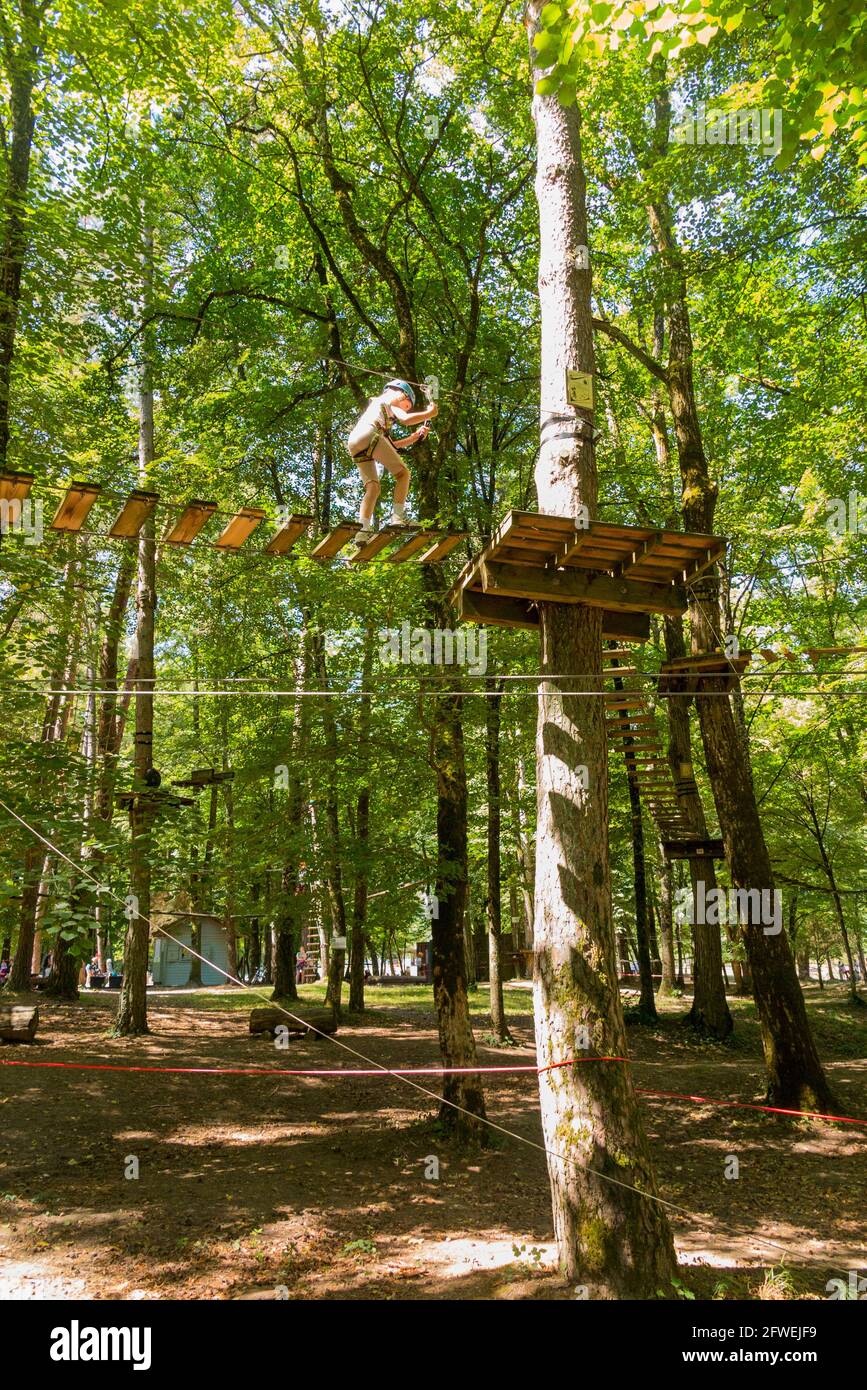 Young girl girls child kid on a children obstacle course activity trail ...