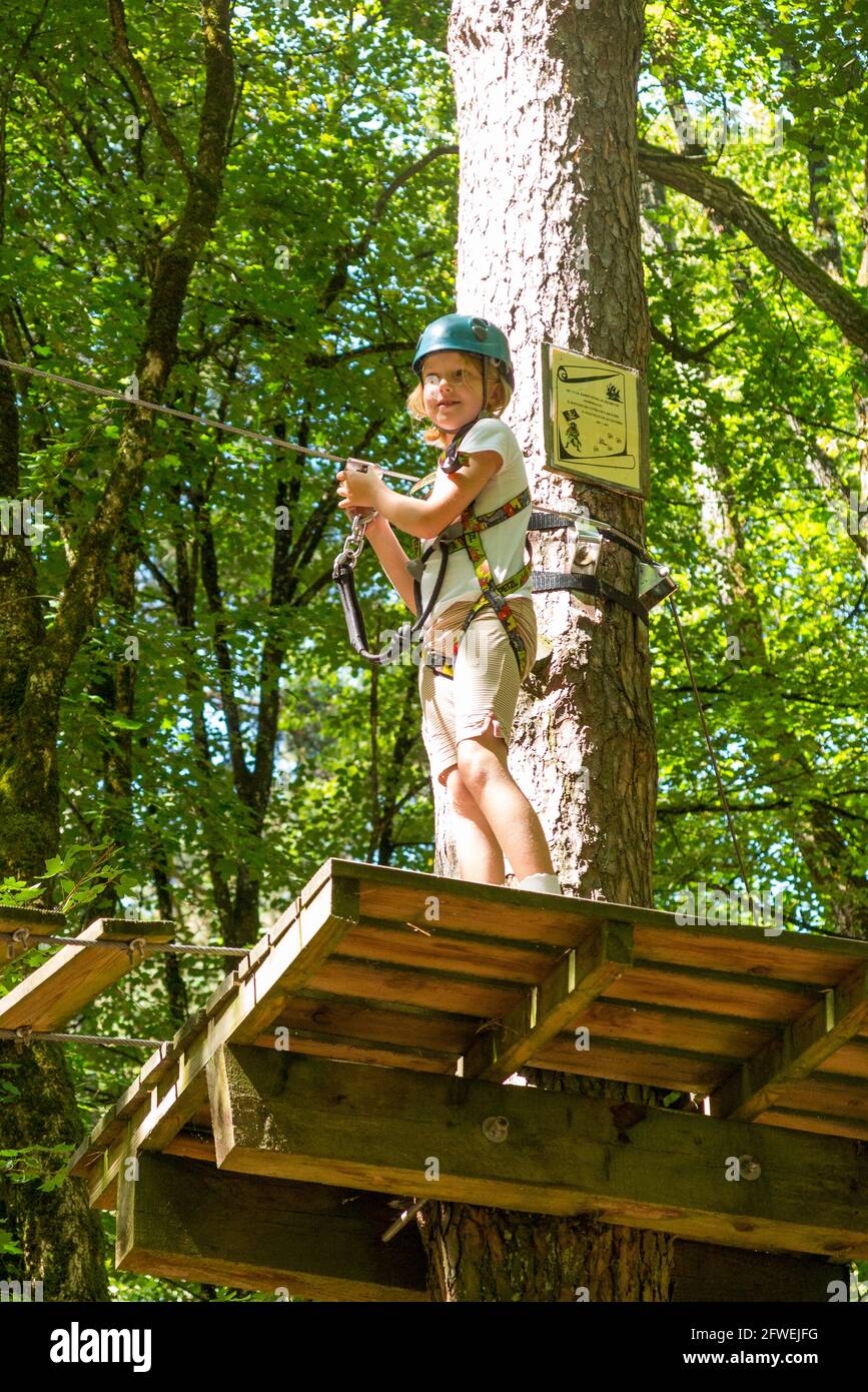 Young girl girls child kid on a children obstacle course activity trail ...