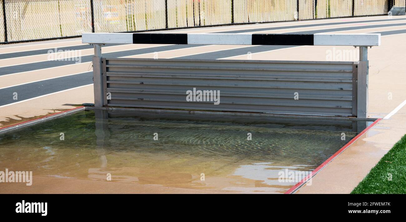 Track steeplechase with a full water pit is set up and ready for a high ...