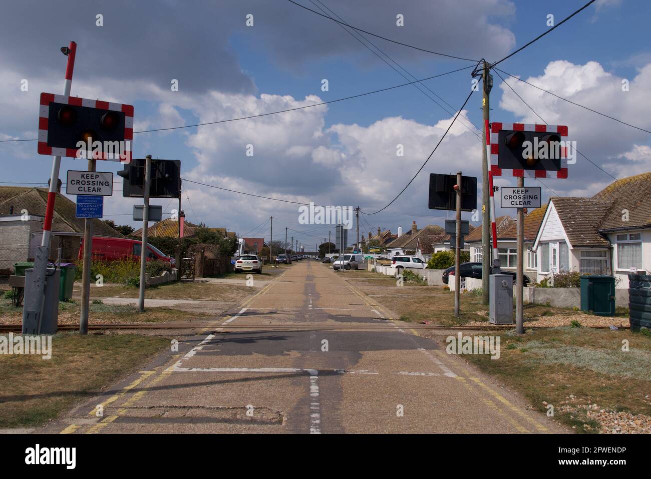 15 May 2021 - Kent, UK: Level railway crossing across suburban road ...
