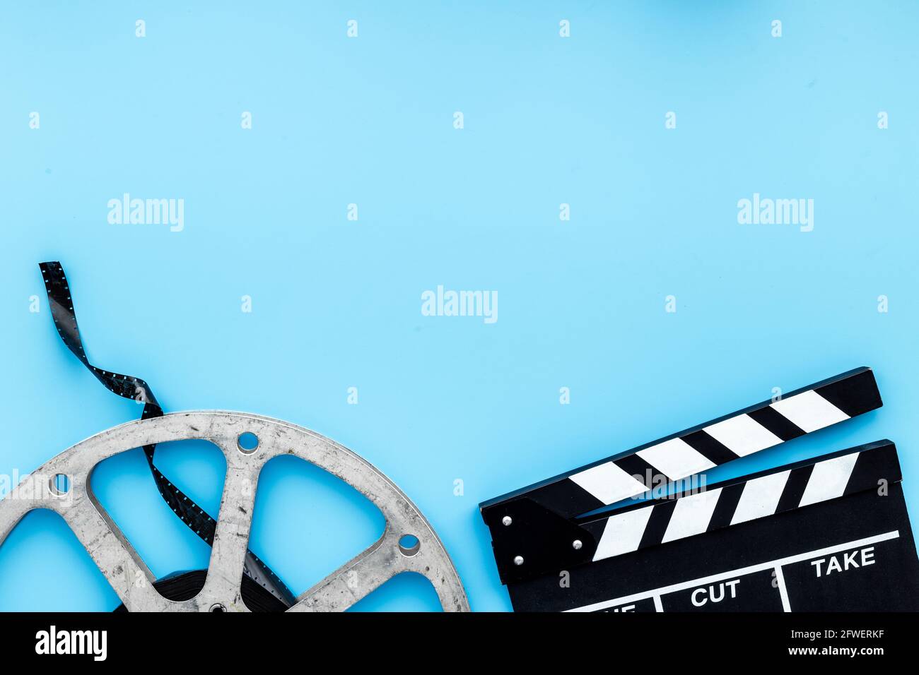 Movie clapper with film reel. Cinema background Stock Photo - Alamy