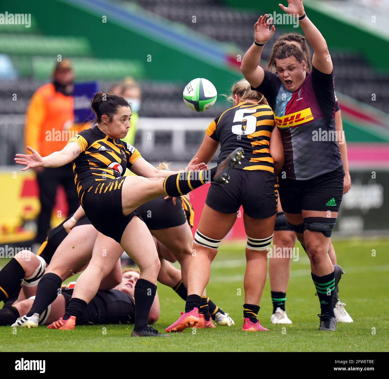 Wasps Sammy Wong kicks the ball clear under pressure from Harlequins ...