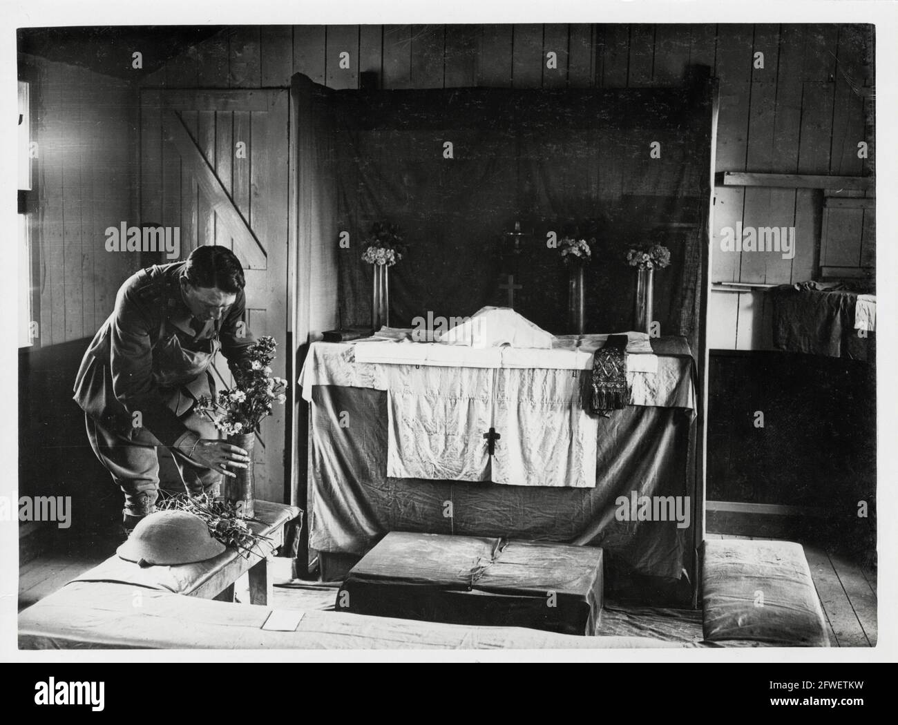 World War One, WWI, Western Front - A priest decorates his altar in a ...