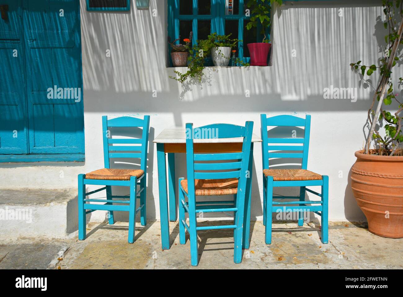 Traditional Greek taverna facade with picturesque furniture in Amorgos ...