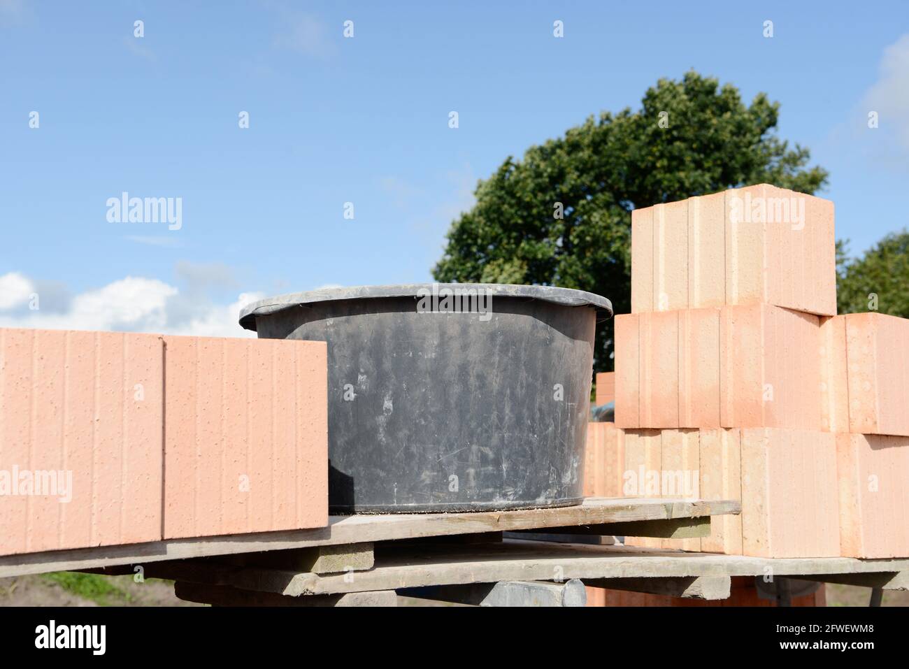 mason bucket and building stones on construction site on wood Stock ...