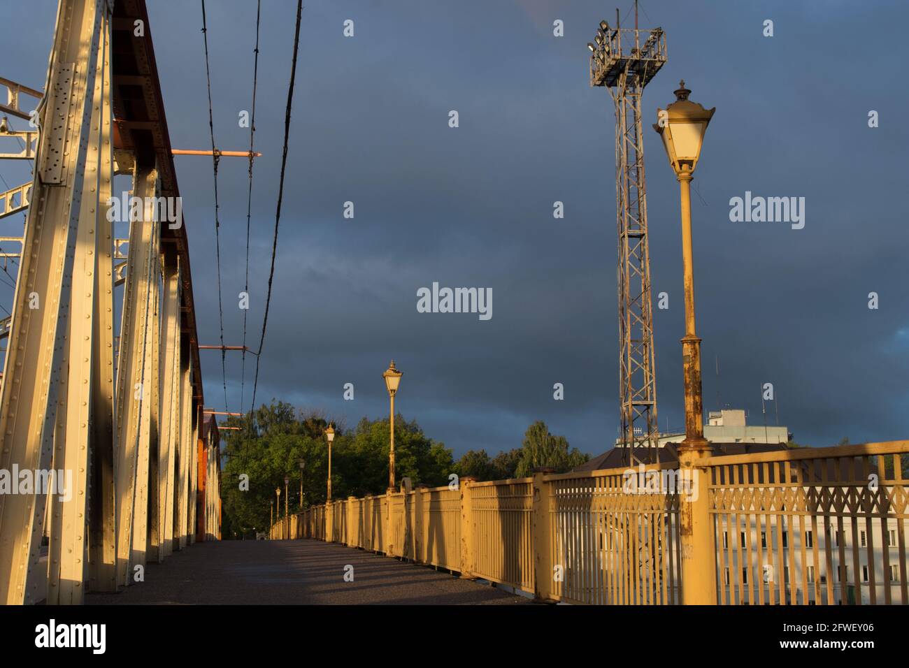 Pedestrian asphalt path on bridge over the railway tracks, left white ...
