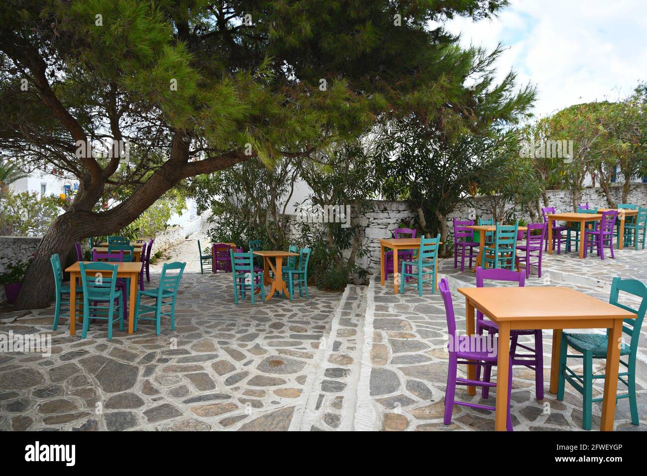 Traditional Greek taverna patio with colorful bistro furniture in Chora ...