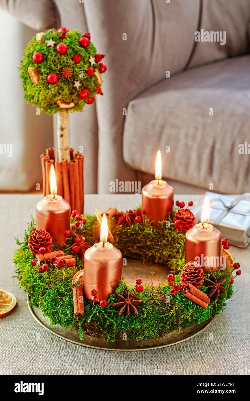 Advent wreath made of moss, cinnamon sticks and rosa canina twigs ...