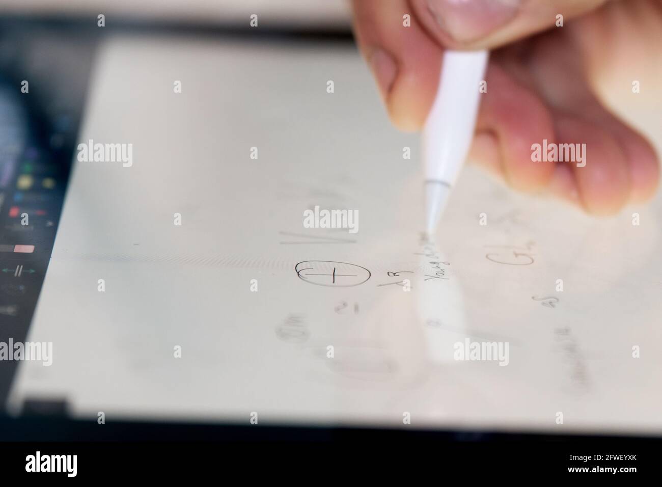 Young mathematics scientist writing math formulas on a digital tablet ...