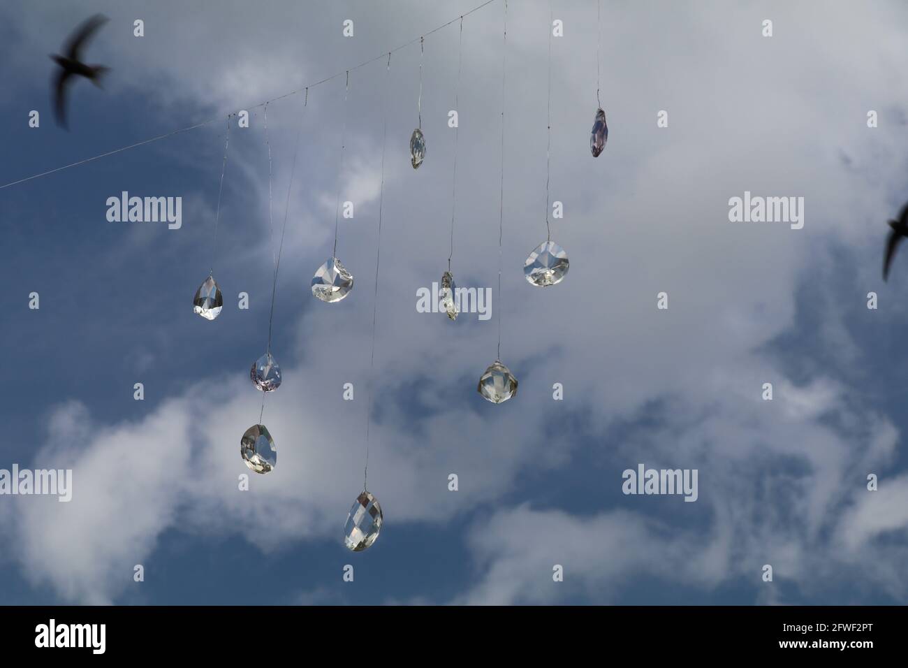 glass crystals hanging in the sky and reflecting the sunlight Stock ...