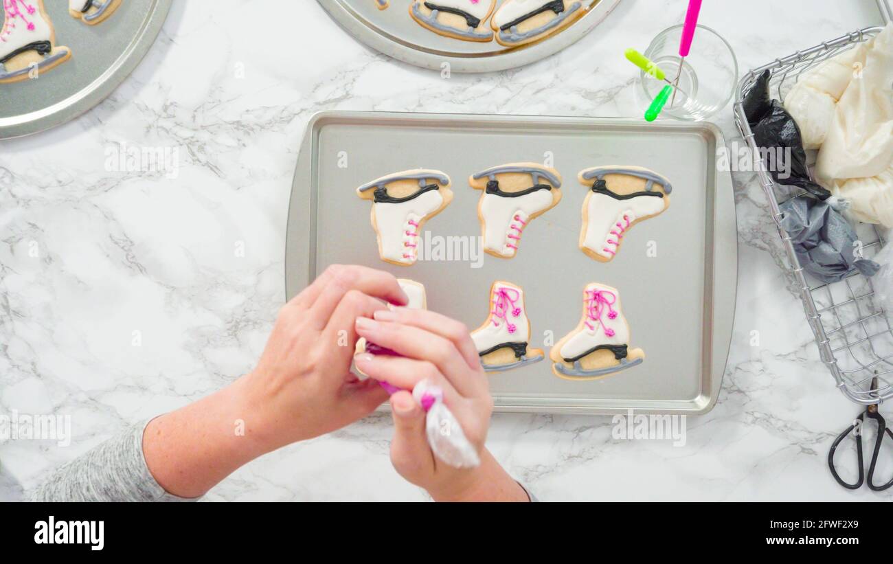 Flat lay. Icing figure skate shaped sugar cookies with royal icing ...