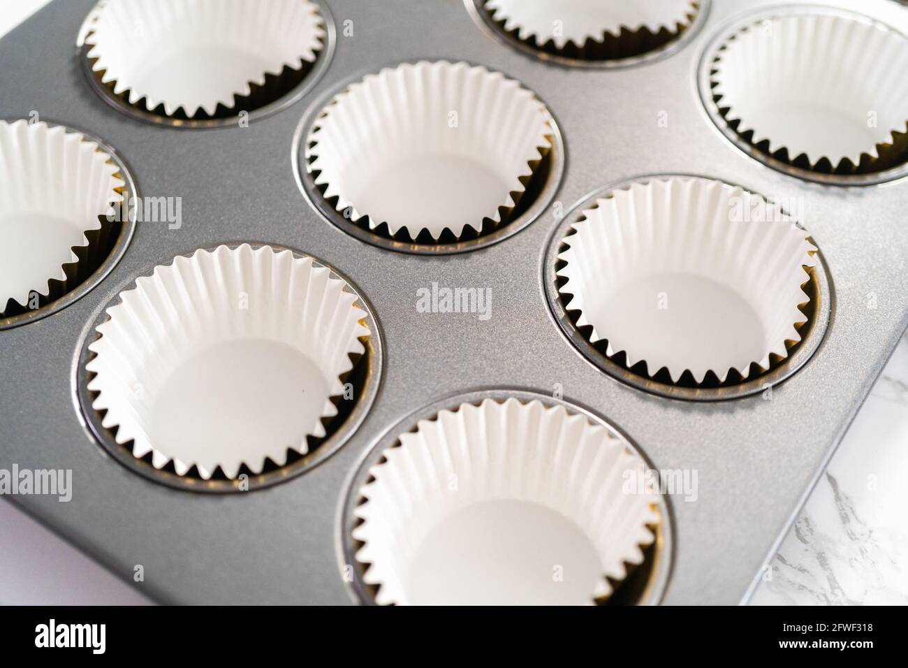 Empty cupcake liners in cupcake pan ready for baking Stock Photo - Alamy