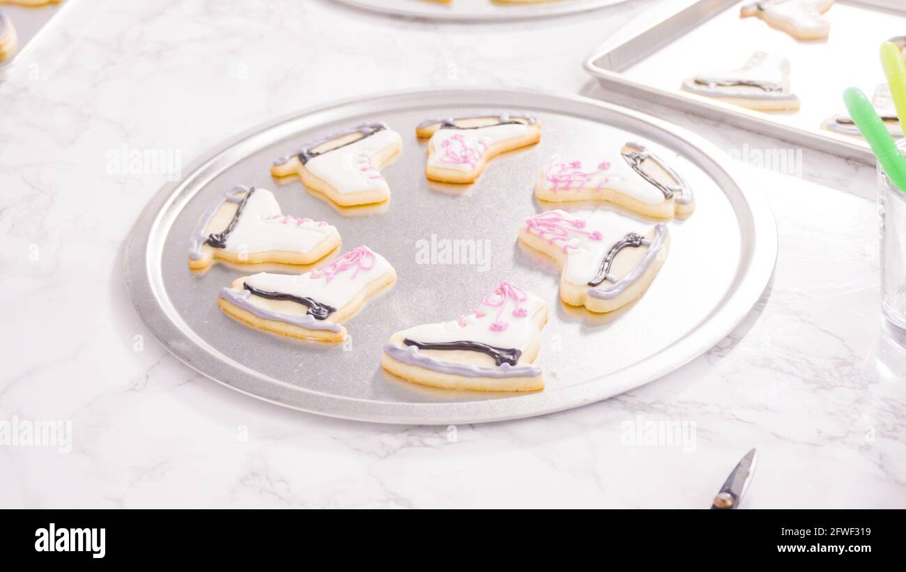 Icing figure skate shaped sugar cookies with royal icing Stock Photo ...