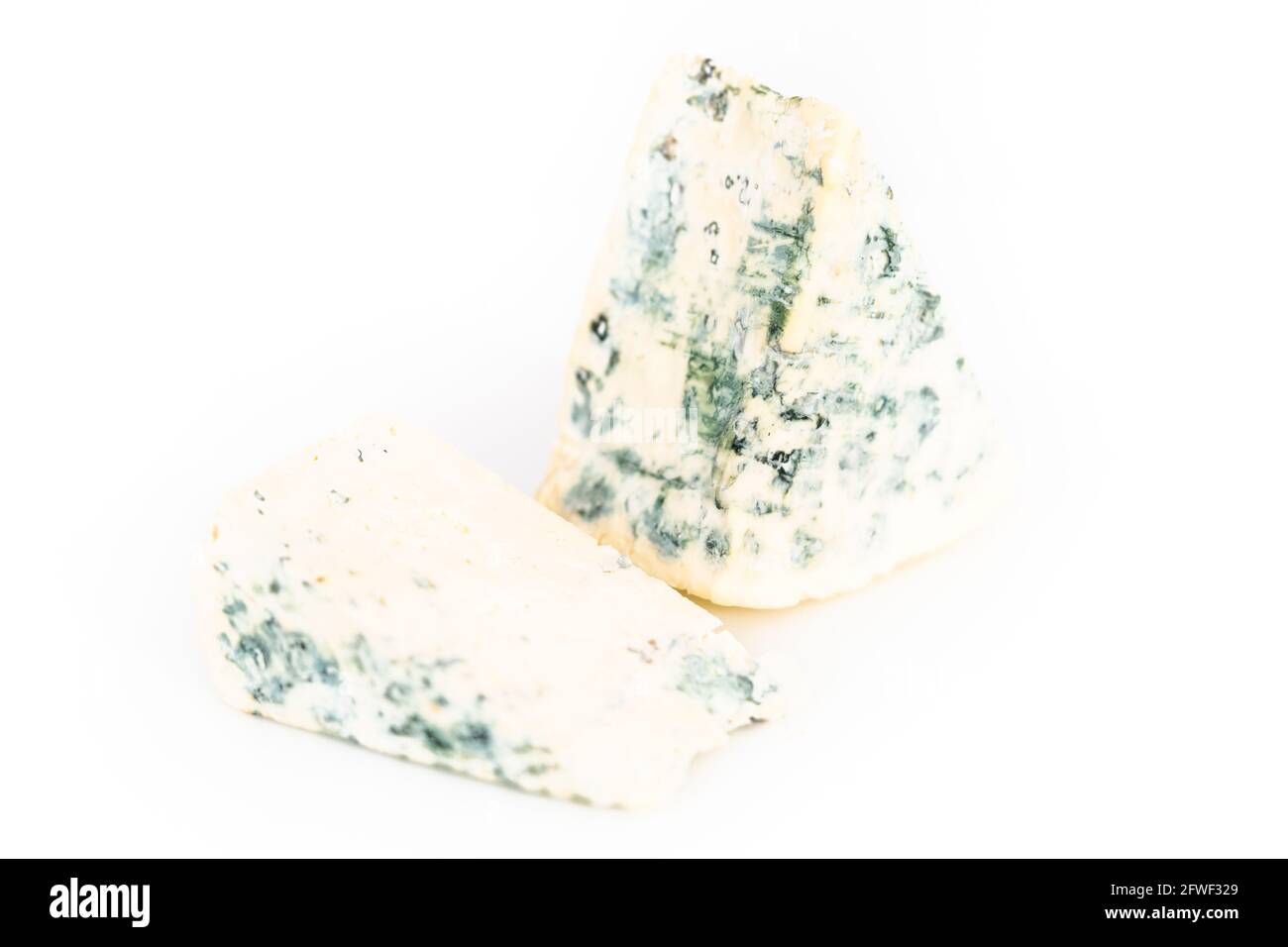 Large slice of blue cheese on a white background Stock Photo - Alamy