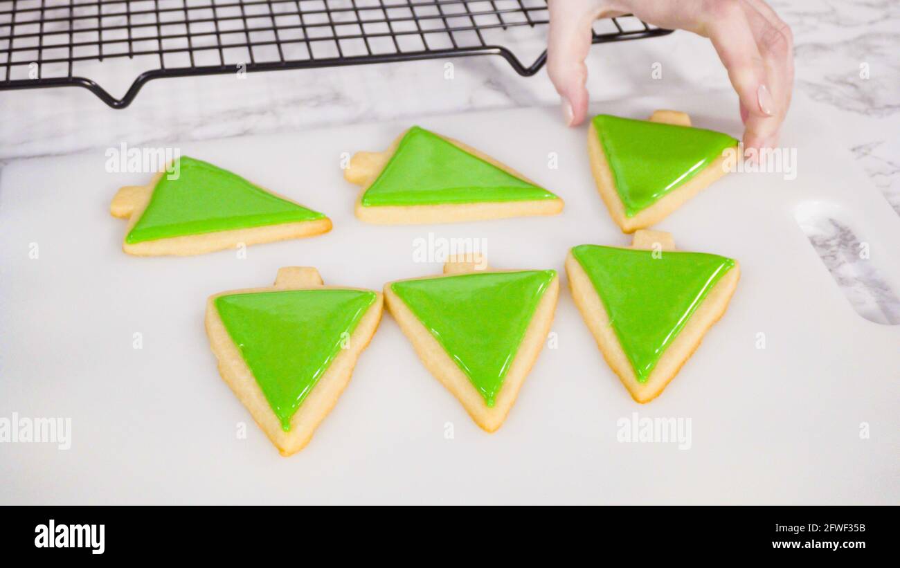 Stp by step. Icing Christmas tree-shaped sugar cookies with green royal ...