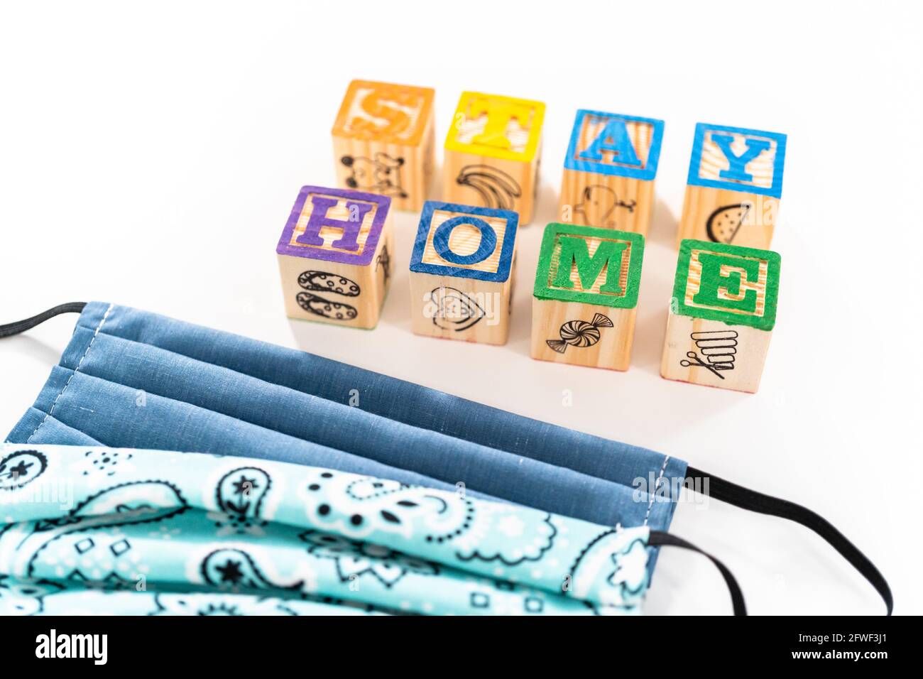 STAY HOME sign out of kids' alphabet blocks with homemade face masks on ...