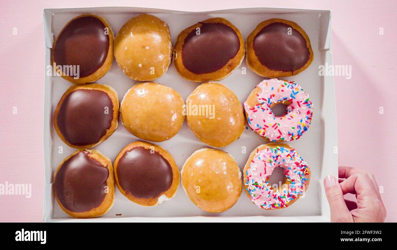 Flat lay. Variety of store-bought doughnuts in a white paper box Stock ...
