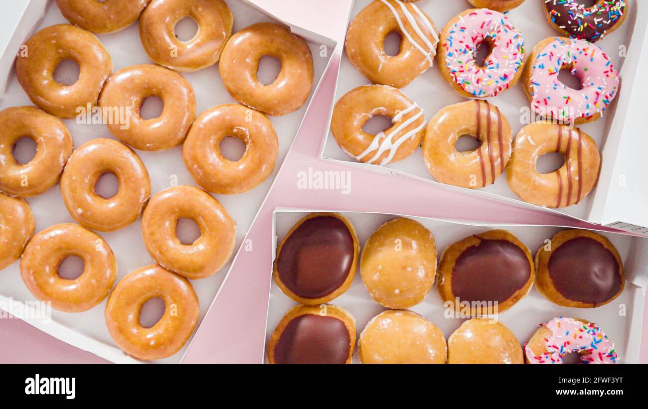 Flat lay. Variety of store-bought doughnuts in a white paper box Stock ...