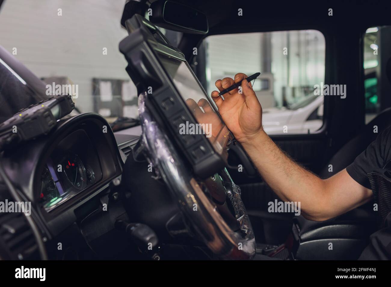 Mid section of mechanic holding a diagnostic tool Stock Photo - Alamy