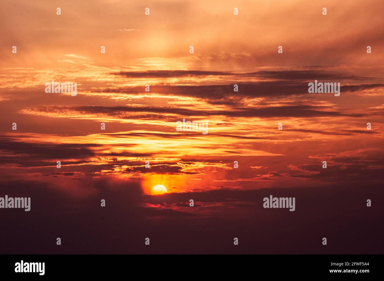 Hidden sun Sunset glow clouds sky Stock Photo - Alamy