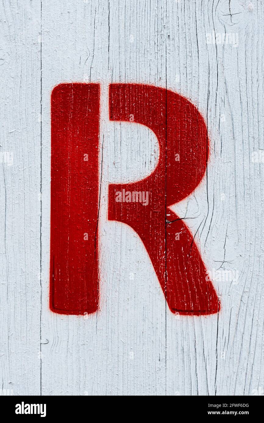 Red letter R sprayed on white painted wooden boards Stock Photo - Alamy