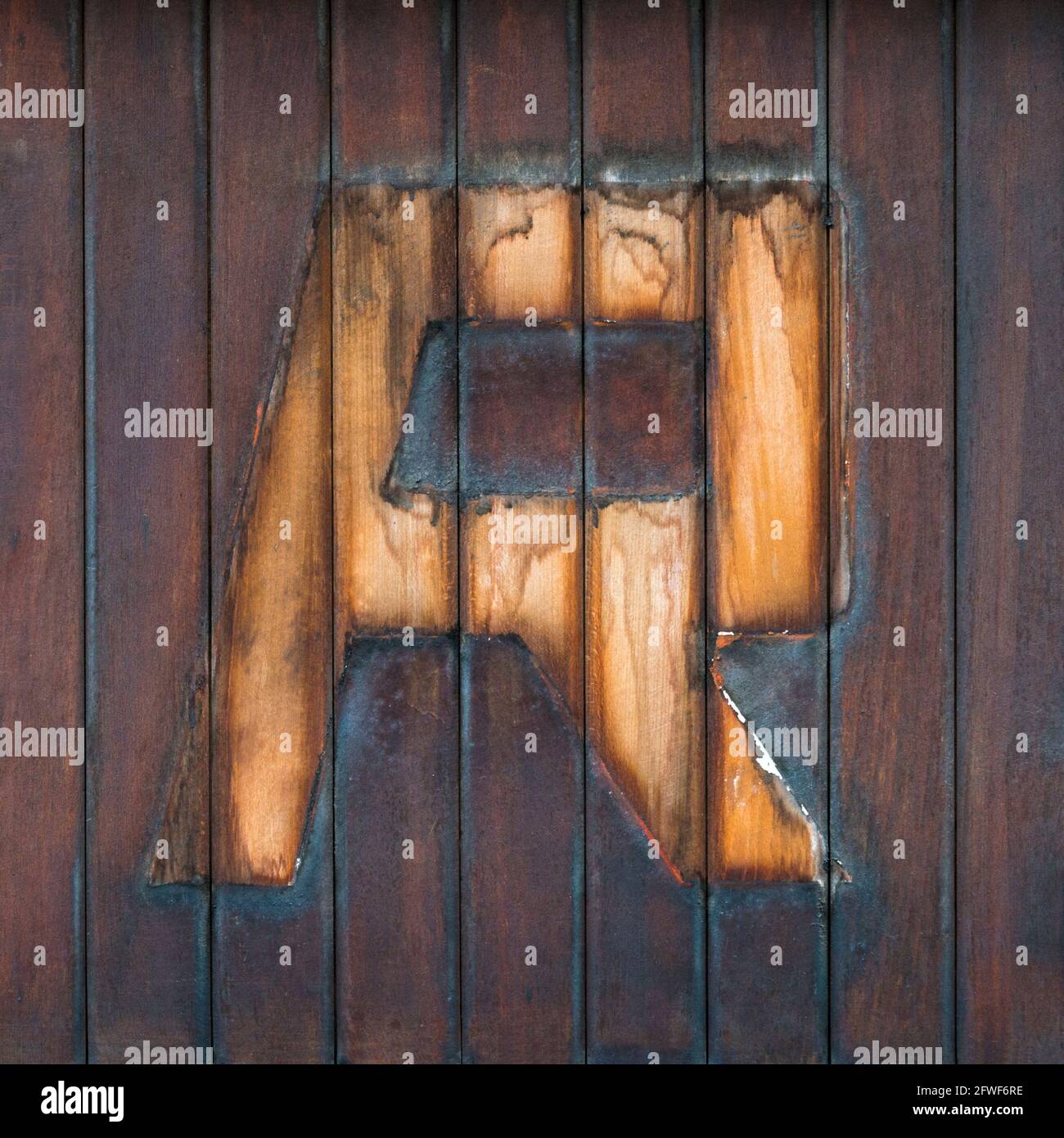 Traces of the dismantled letter R on brown wooden boards Stock Photo ...