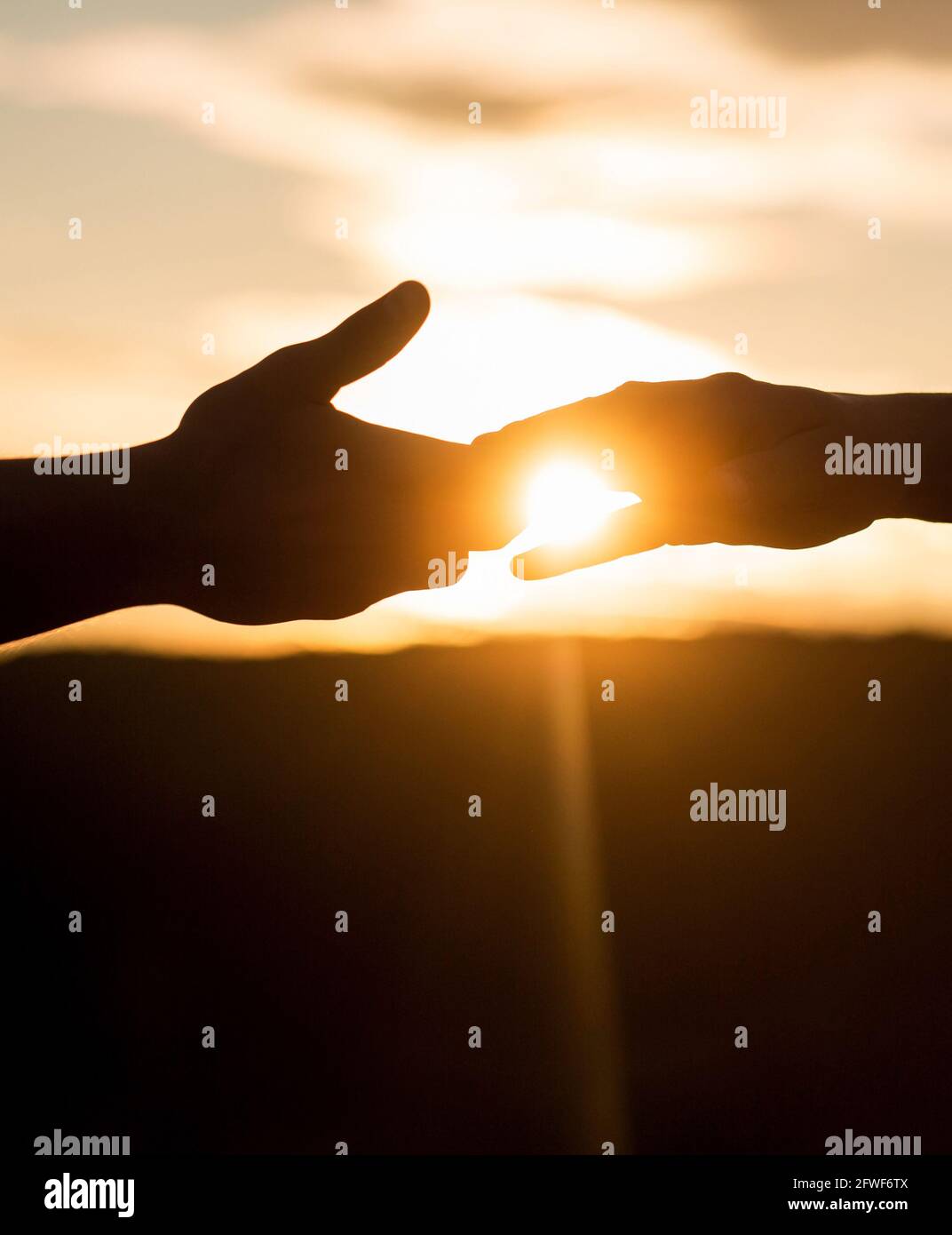 Two hands silhouette on sky background, connection or help concept. Outstretched hands ...