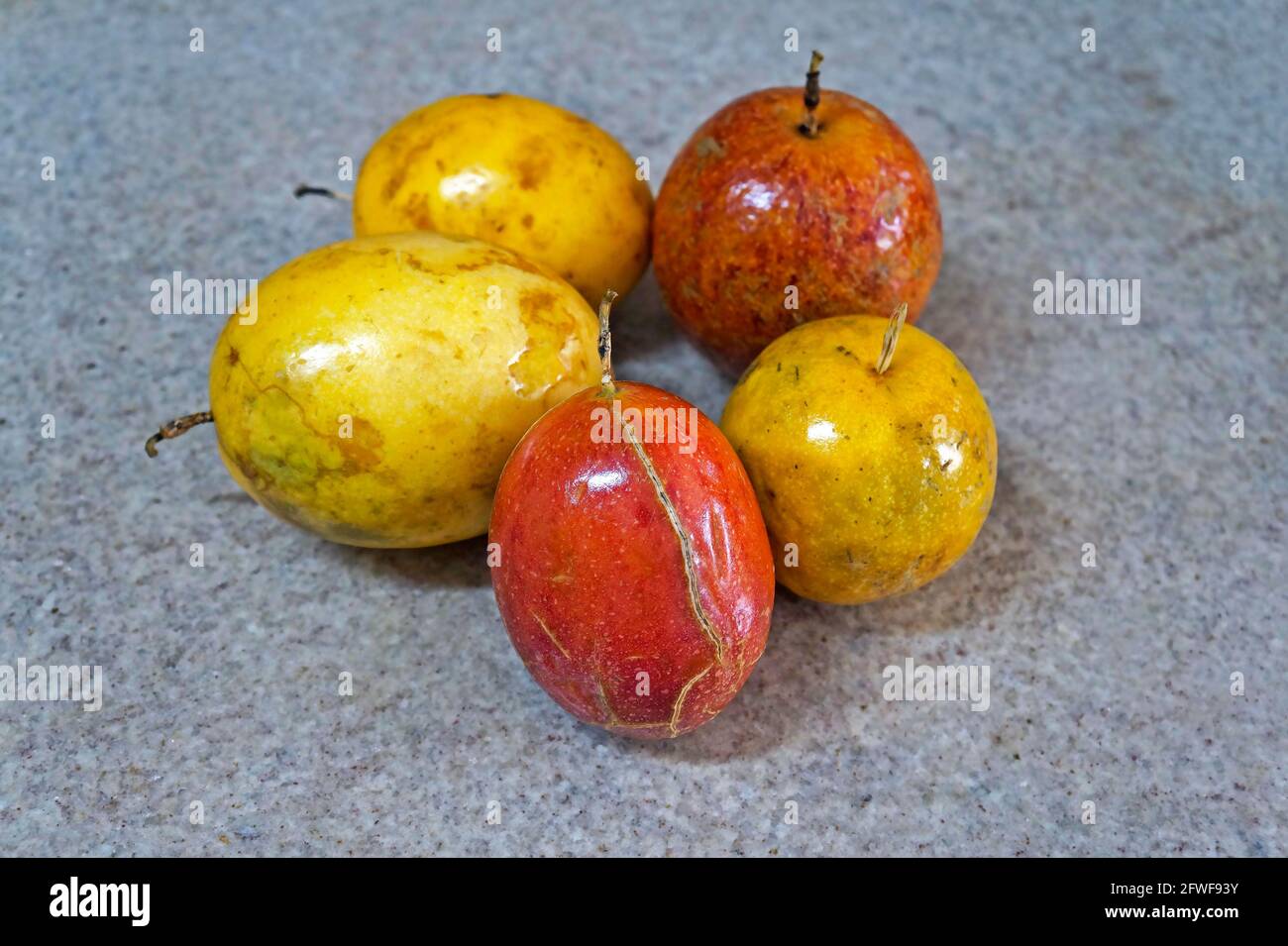 Passion fruits on granite background Stock Photo - Alamy