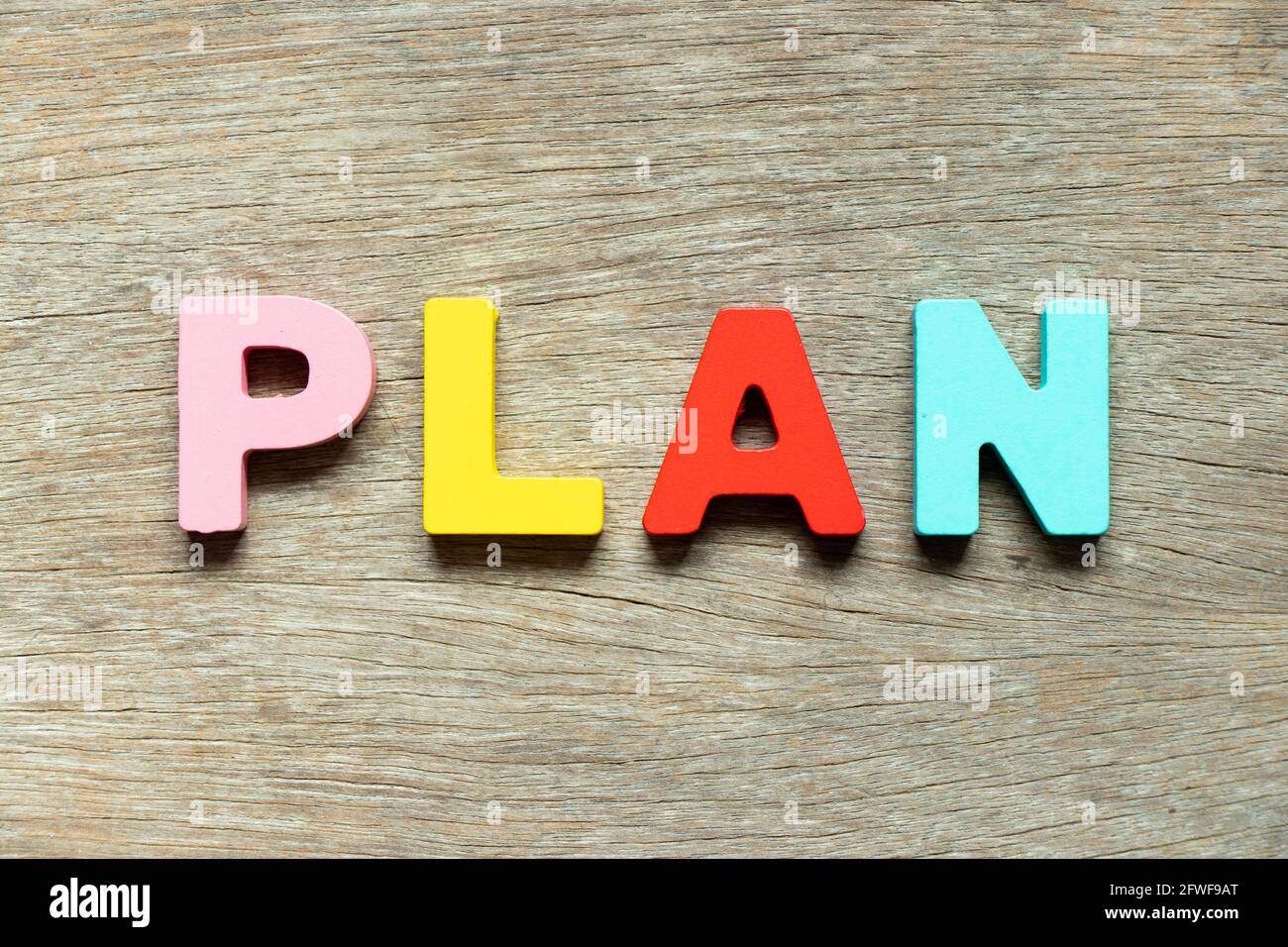 Color alphabet letter in word plan on wood background Stock Photo - Alamy