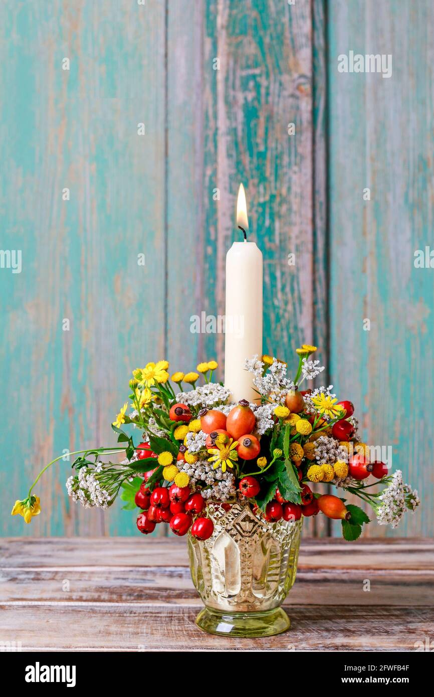 Beautiful candle holder decorated with autumn wild plants and flowers ...