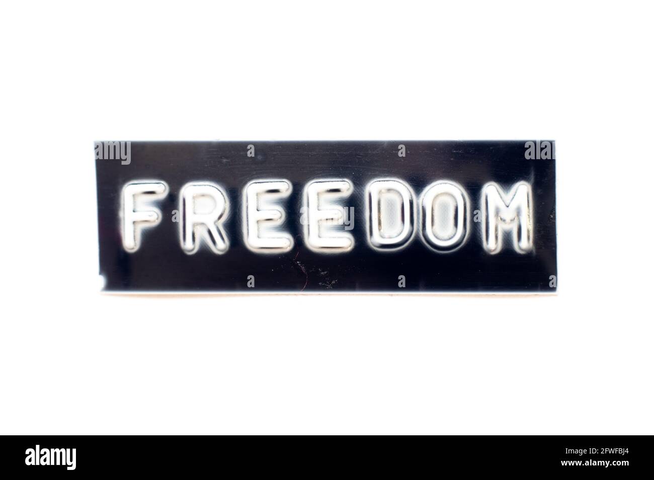 Embossed letter in word freedom on black banner with white background ...