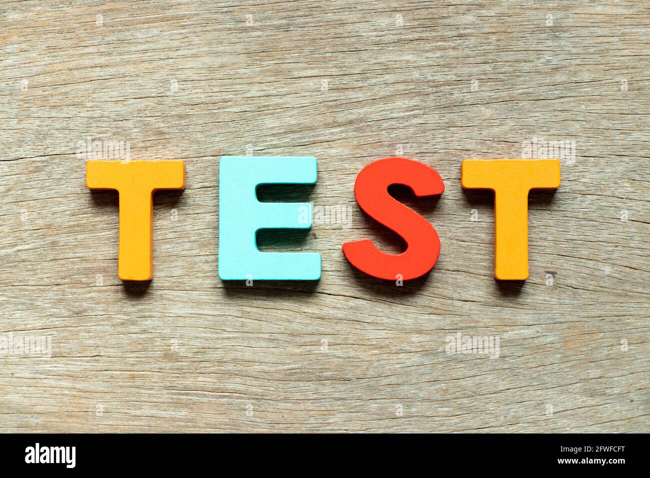 Color alphabet letter in word test on wood background Stock Photo - Alamy