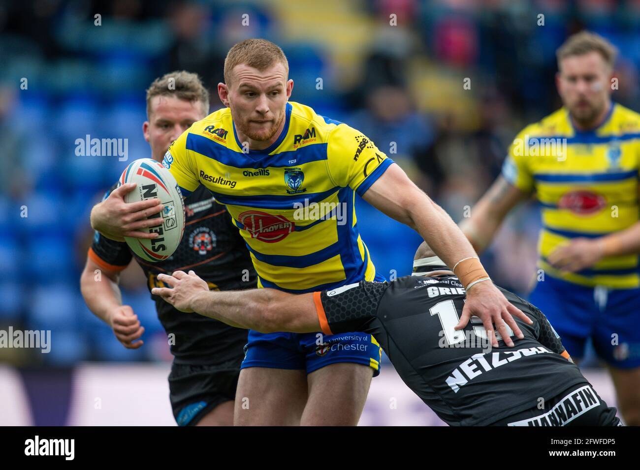 Jack Hughes (12) of Warrington Wolves evades the tackle of George ...
