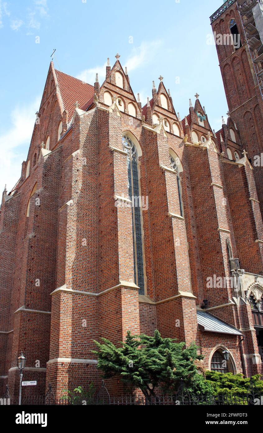 The soaring gothic windows and massive buttresses of the church of the ...