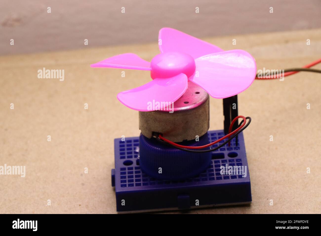 Simple electronic circuit showing dc motor connected to breadboard ...