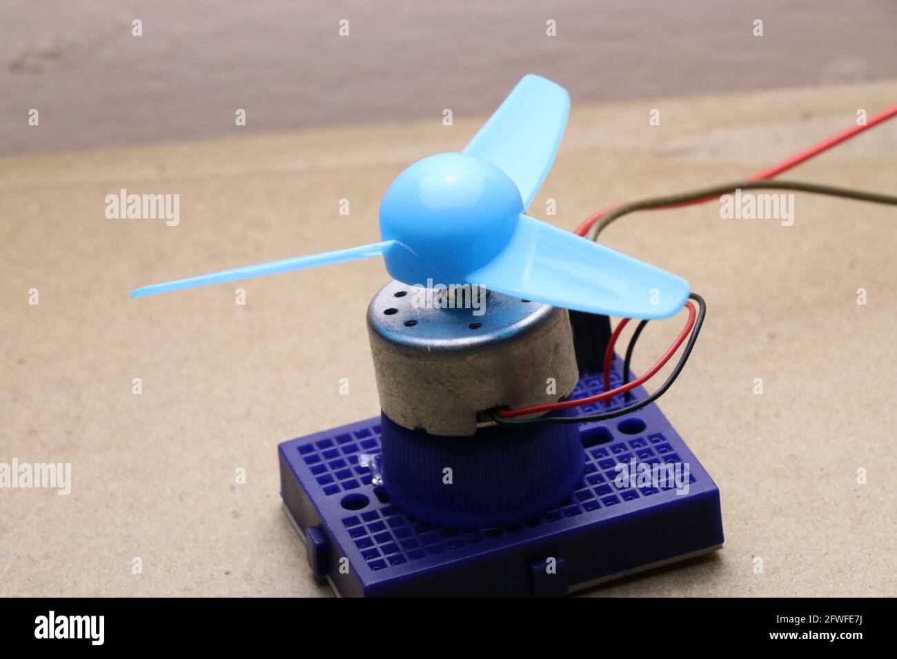 DC Motor with propeller attached to shaft connected to breadboard ...