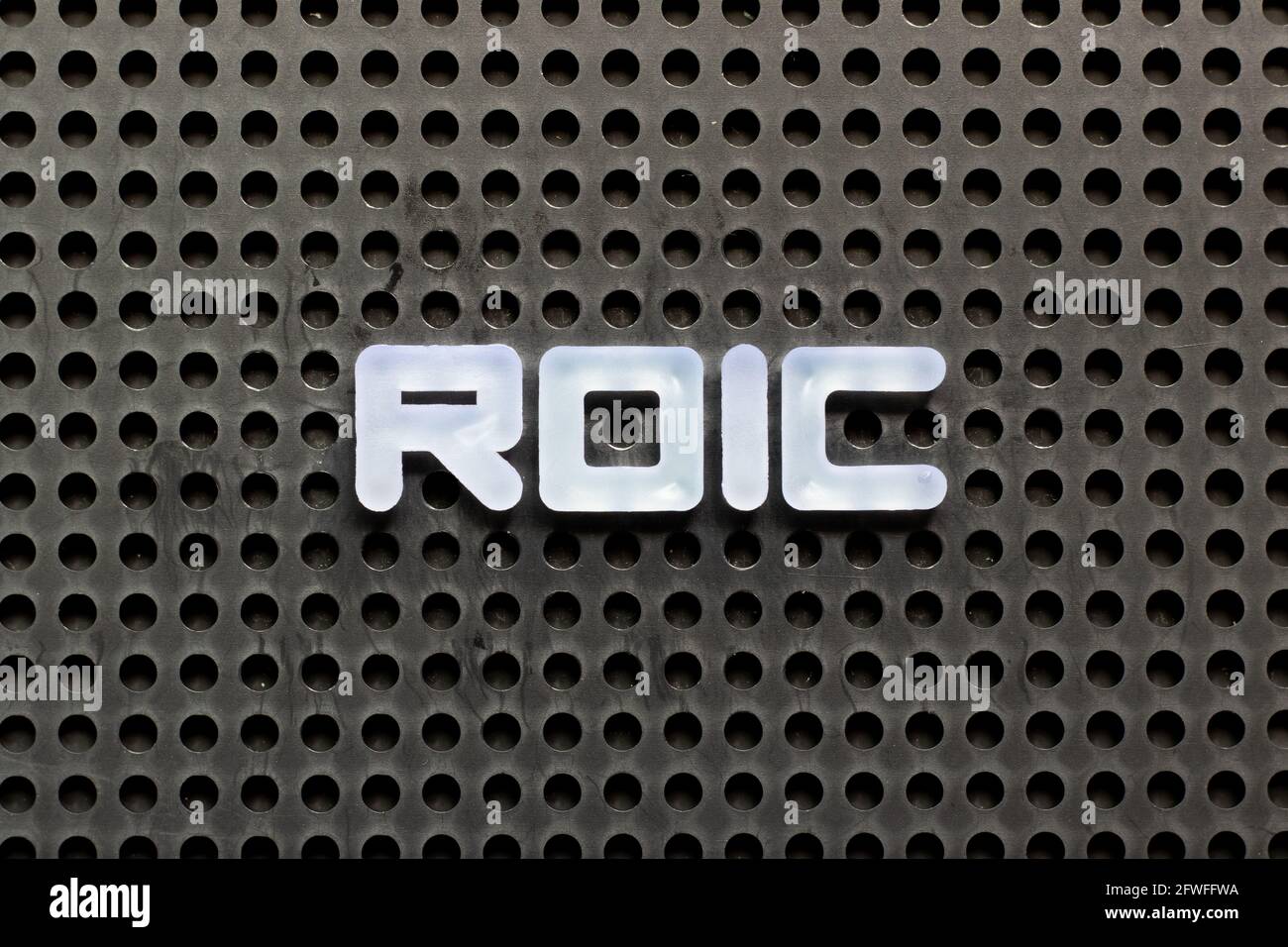 White color letter in word ROIC (Abbreviation of Return on invested ...