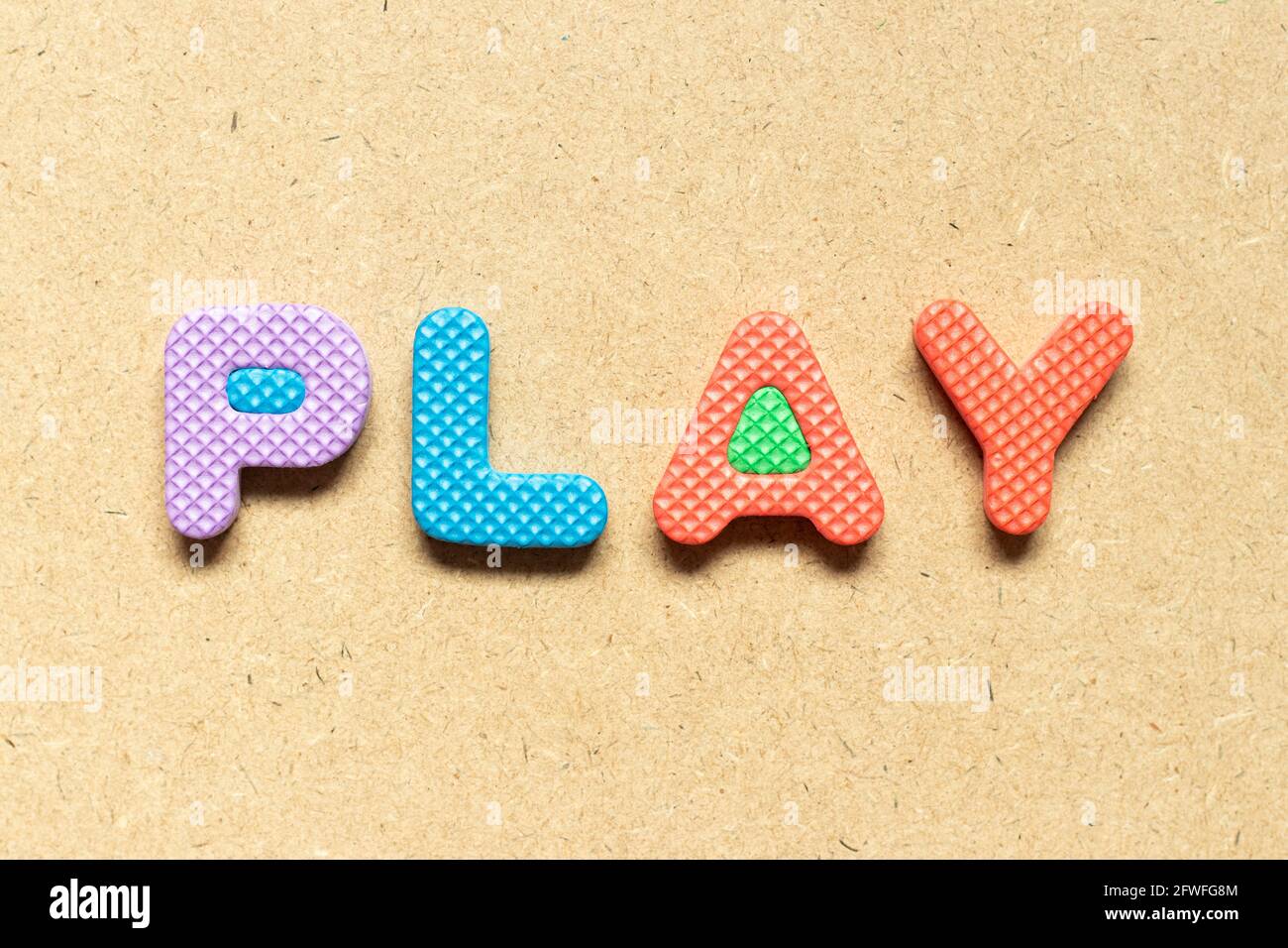 Foam alphabet letter in word play on wood background Stock Photo - Alamy