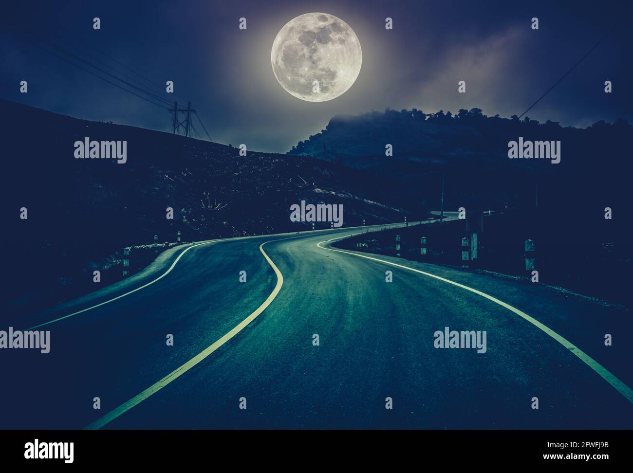 Landscape of full moon with curvy roadway in forest at national park ...