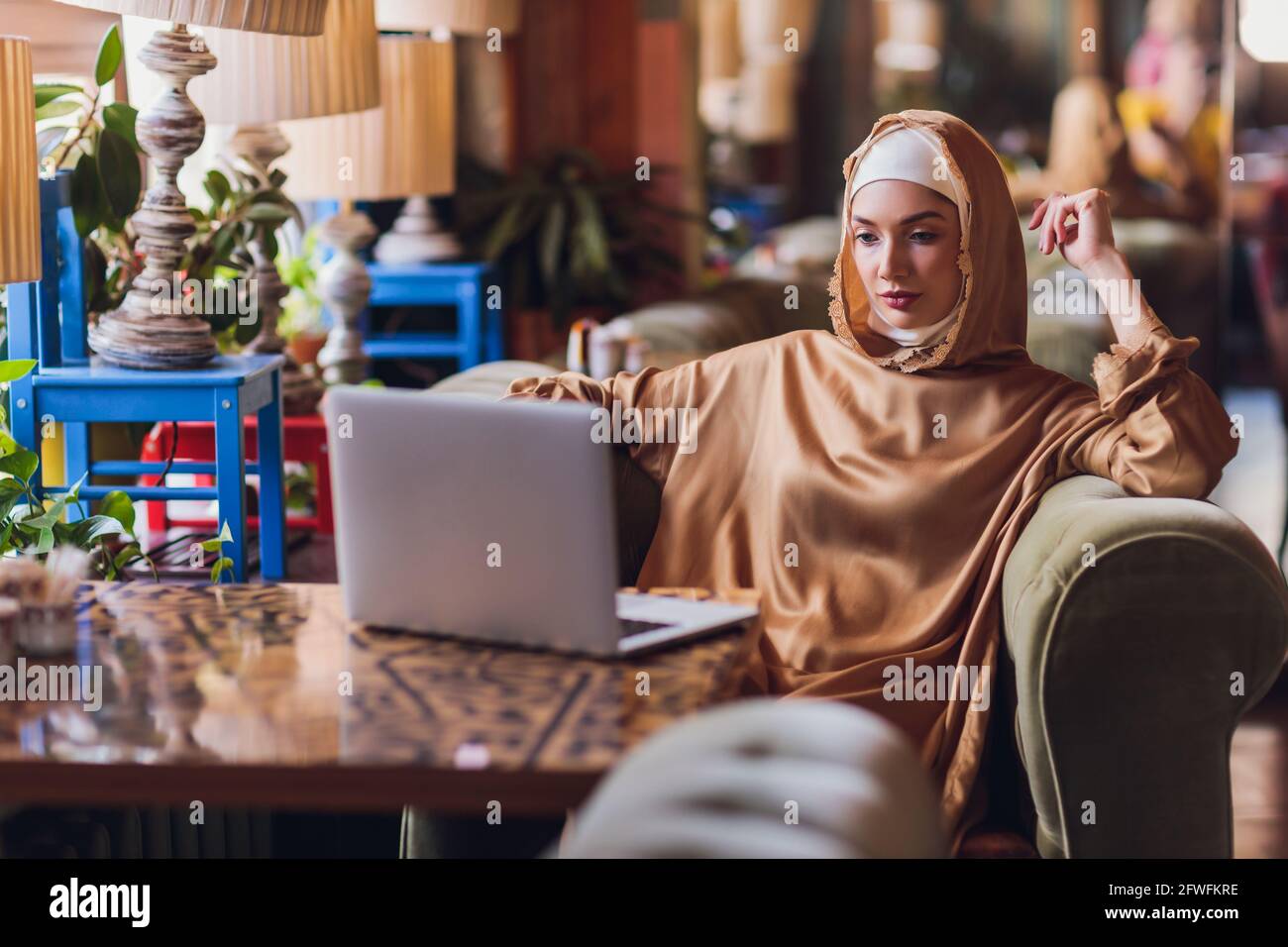 Beautiful Arabic business woman working on computer Stock Photo - Alamy