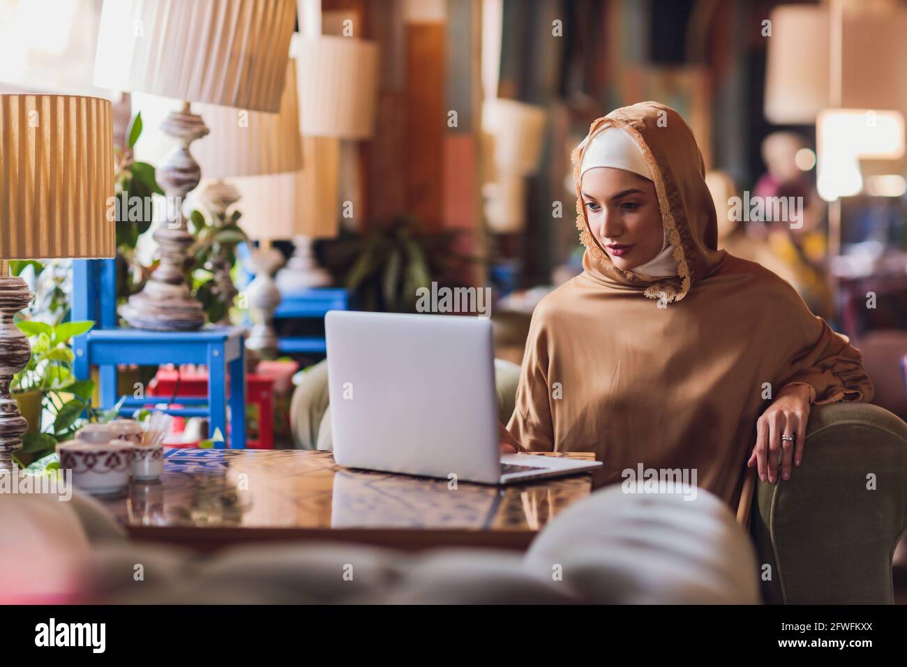 Beautiful Arabic business woman working on computer Stock Photo - Alamy